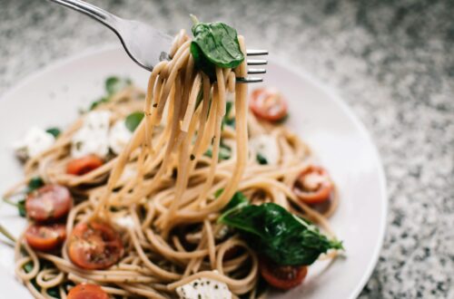 selective focus photography of pasta with tomato and basil